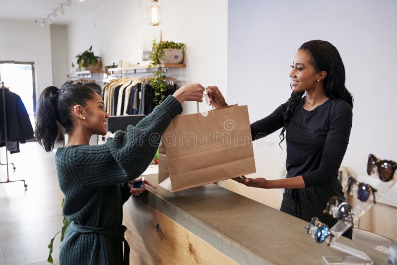 Woman Serving Customer at the Counter in a Clothing Store Stock Image ...