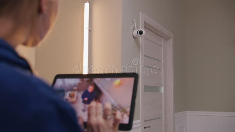 Woman Sets Up CCTV Camera Using Tablet Stock Video - Video of woman ...