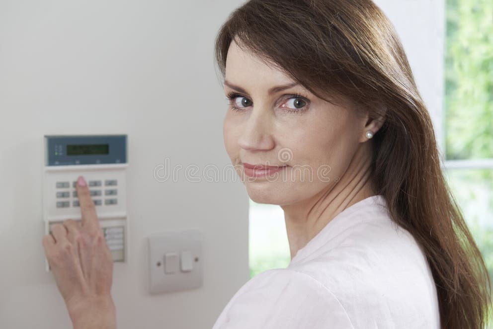 Woman Setting Control Panel on Home Security System Stock Image - Image ...