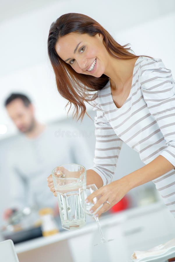 Woman setting dining table stock photo. Image of dish - 83390470