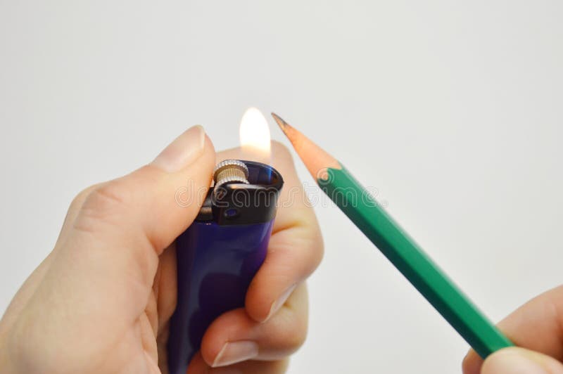 Woman Setting Fire To Pencil Lead with Lighter on White Background ...