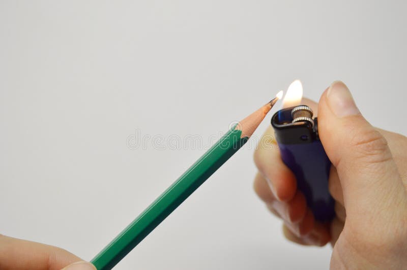 Woman Setting Fire To Pencil Lead with Lighter on White Background ...