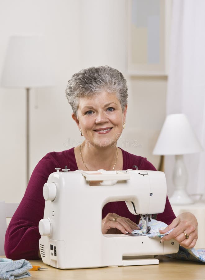 Woman on Sewing Machine stock image. Image of indoors - 10185239