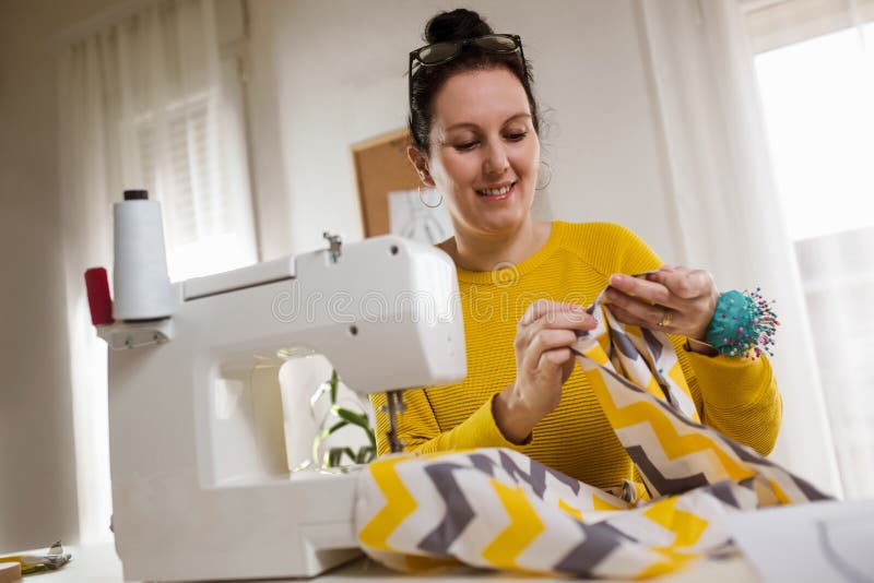 Woman Sewing on a Sewing Machine at Her Home Stock Photo - Image of ...
