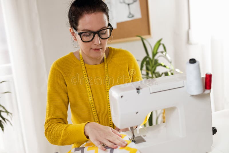 Woman Sewing on a Sewing Machine at Her Home Stock Photo - Image of ...