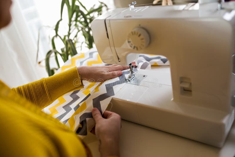 Woman Sewing on a Sewing Machine at Her Home Stock Photo - Image of ...