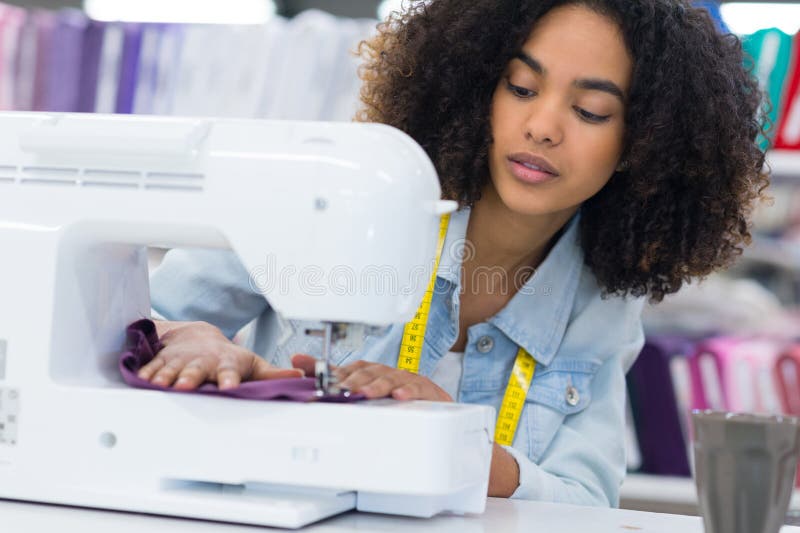 Woman on sewing machine stock image. Image of housework - 272190053