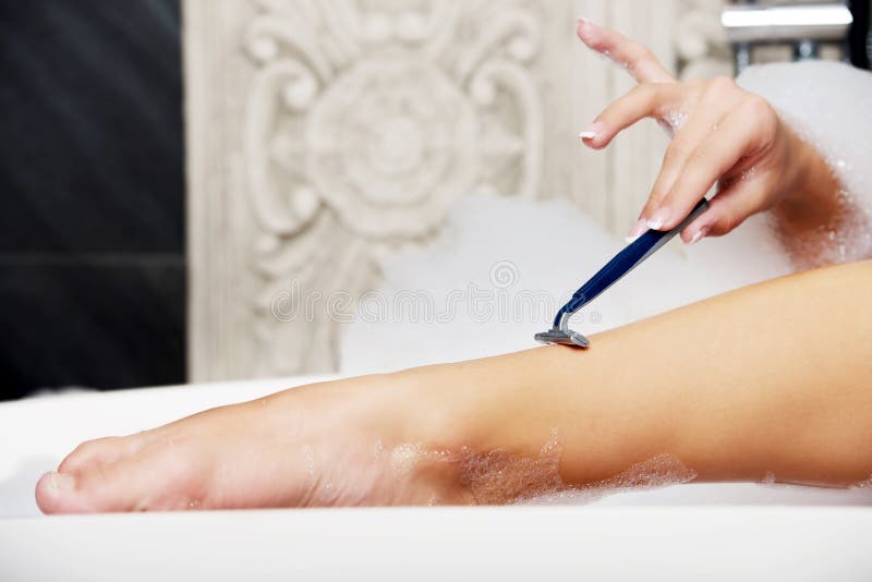Woman shaving her leg. stock photo. Image of caucasian - 53680124