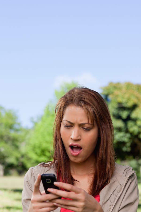 Woman with a Shocked while Reading a Text Message Stock Photo - Image ...