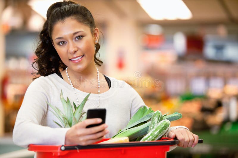 Woman Using Mobile Phone while Shopping in Supermarket Stock Image ...