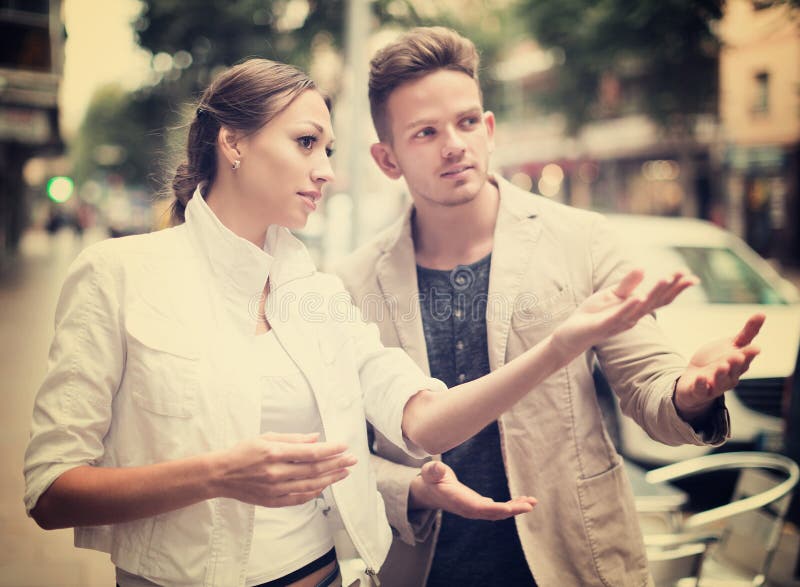 Woman Showing Direction To Guy Stock Image - Image of casual, facing ...
