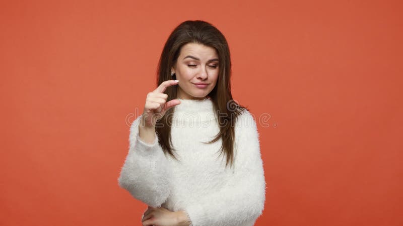 Woman Showing a Little Bit Gesture Looking at Camera with Sarcastic ... Woman Showing a Little Bit Gesture Looking at Camera with Sarcastic ...