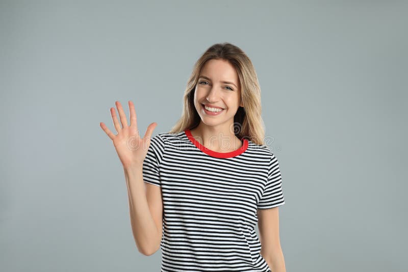 Woman Showing Number Five with Her Hand on Light Grey Background Stock ...