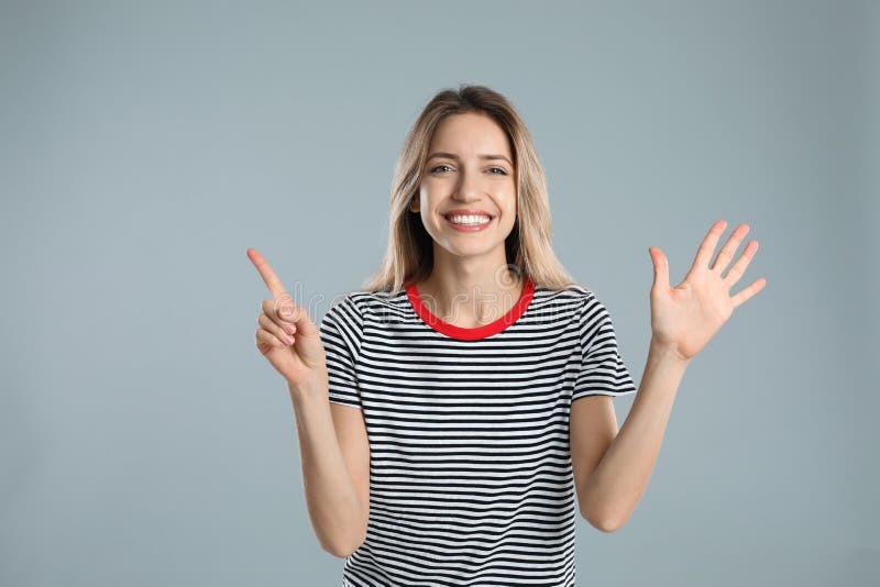 Woman Showing Number Six with Her Hands on Light Grey Background Stock ...