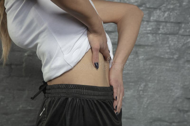 Woman Shows that she Has Back Pain, Bending Forward Stock Photo - Image ...