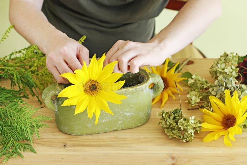 Woman Shows How To Make Floral Arrangement with Sunflowers and ... Woman Shows How To Make Floral Arrangement with Sunflowers and ...