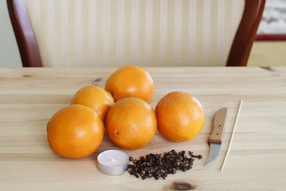 Woman Shows How To Make Orange Pomander Ball with Candle Stock Photo ...