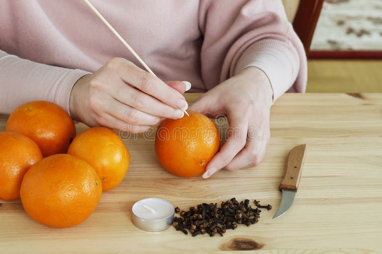 Woman Shows How To Make Orange Pomander Ball with Candle Stock Photo ...