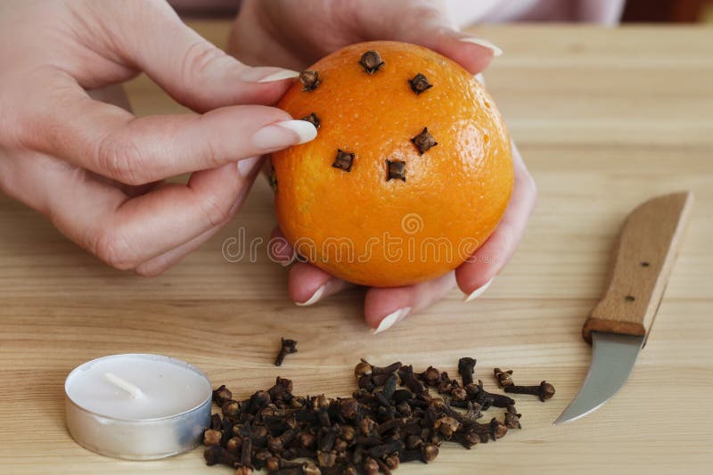 Woman Shows How To Make Orange Pomander Ball with Candle Stock Image ...
