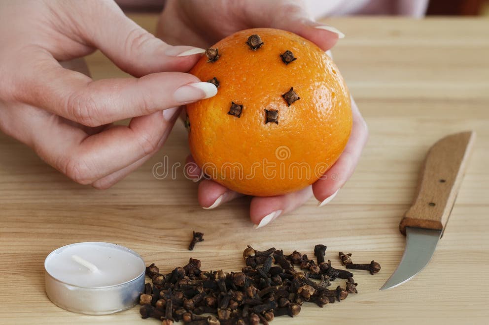 Woman Shows How To Make Orange Pomander Ball with Candle Stock Image ...