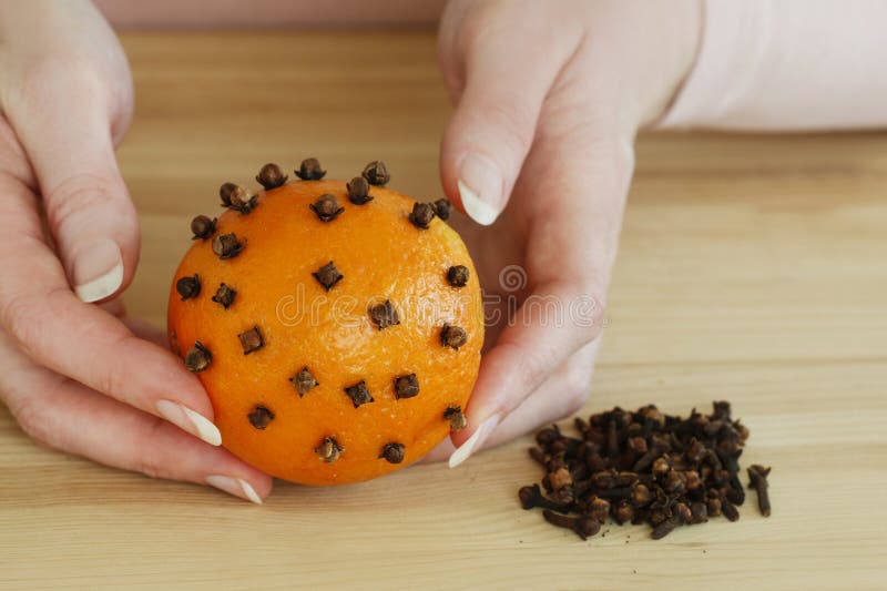 Woman Shows How To Make Orange Pomander Ball with Candle Stock Image ...