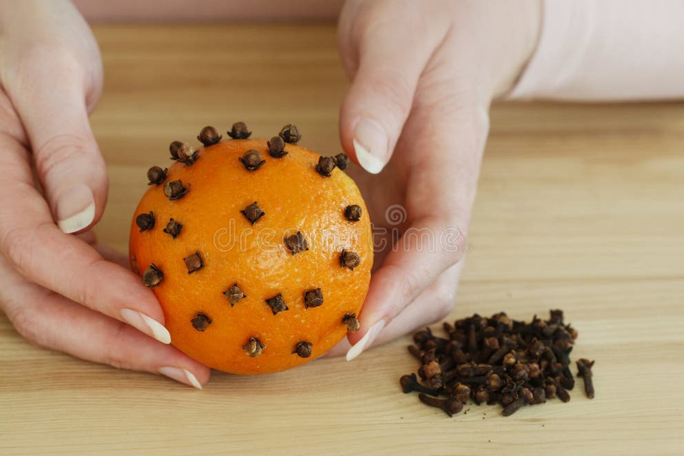 Woman Shows How To Make Orange Pomander Ball with Candle Stock Image ...