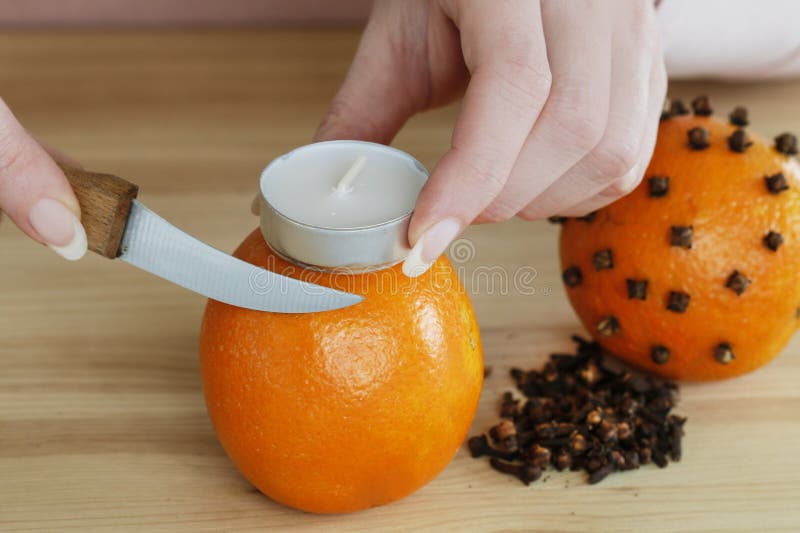 Woman Shows How To Make Orange Pomander Ball with Candle Stock Photo ...