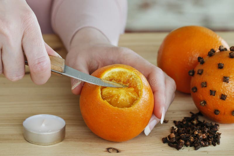 Woman Shows How To Make Orange Pomander Ball with Candle Stock Image ...