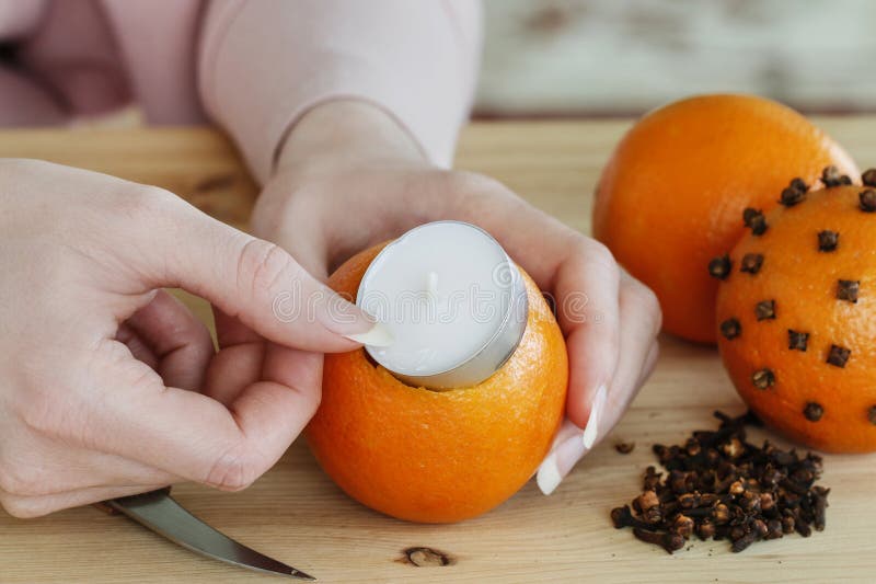 Woman Shows How To Make Orange Pomander Ball with Candle Stock Photo ...