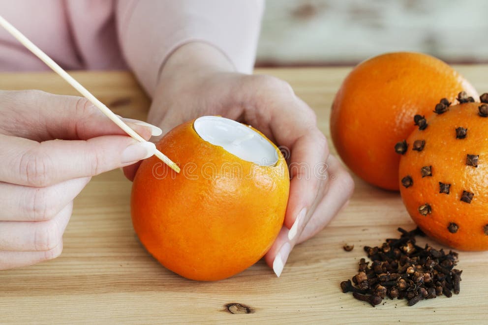 Woman Shows How To Make Orange Pomander Ball with Candle Stock Photo ...