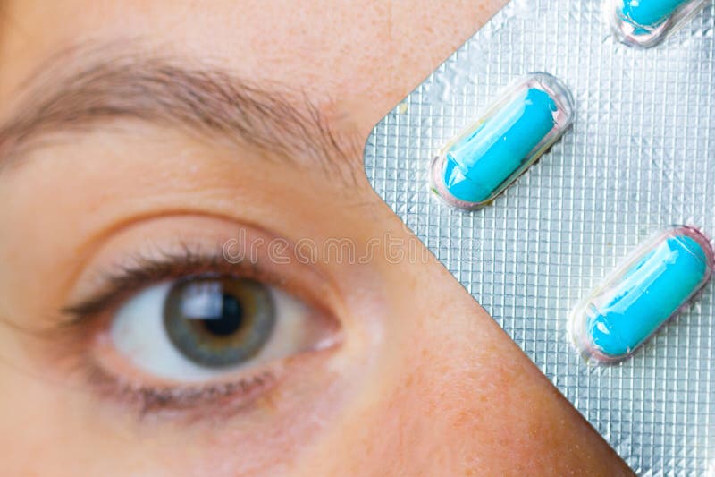 Woman shows yellow pill stock photo. Image of nurse - 160433536