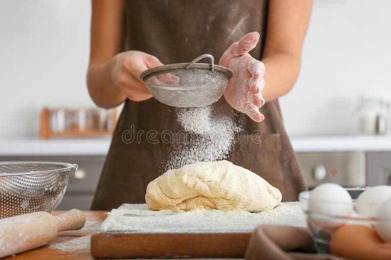 Woman Sieving Flour in Kitchen Stock Photo - Image of ingredient, board ...
