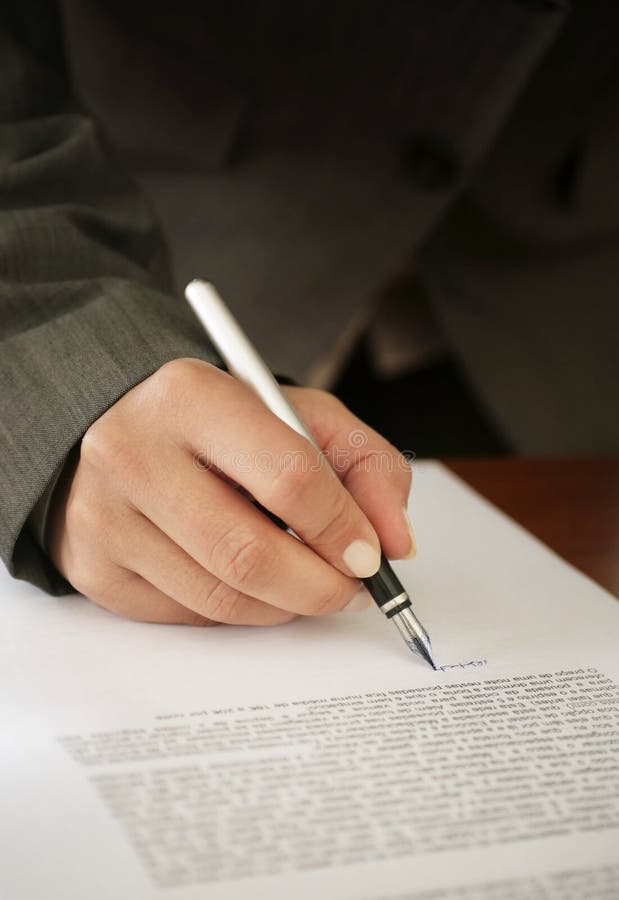 Woman signing a document stock image. Image of office - 6218869