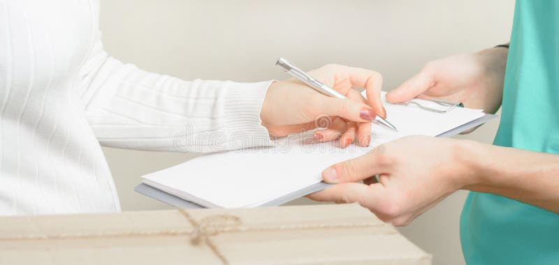 Woman Signing Receipt of Delivery Package. Stock Image - Image of ...