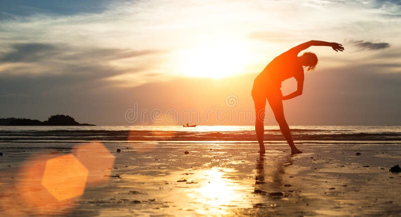 Woman Silhouette Exercise on the Beach at Sunset. Sport. Stock Image ...
