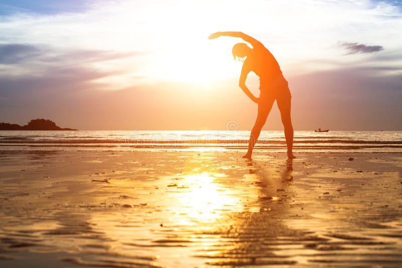 Woman Silhouette Exercise on the Beach at Sunset. Stock Photo - Image ...