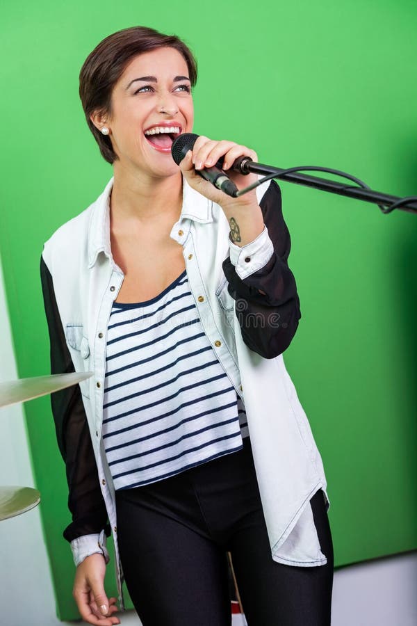 Woman Singing while Holding Microphone in Stock Image - Image of ...