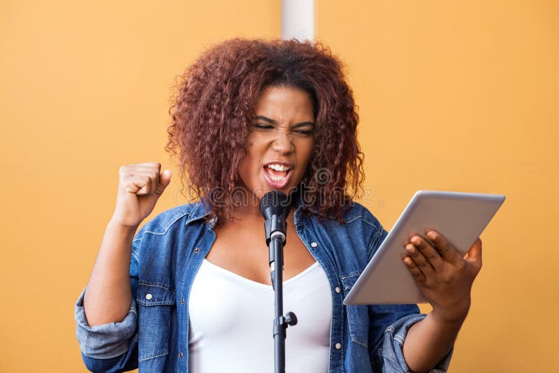 Woman Singing while Holding Tablet Computer Stock Photo - Image of ...