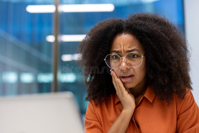 Concerned Female Looking at a Computer Screen in a Modern Office Stock ...