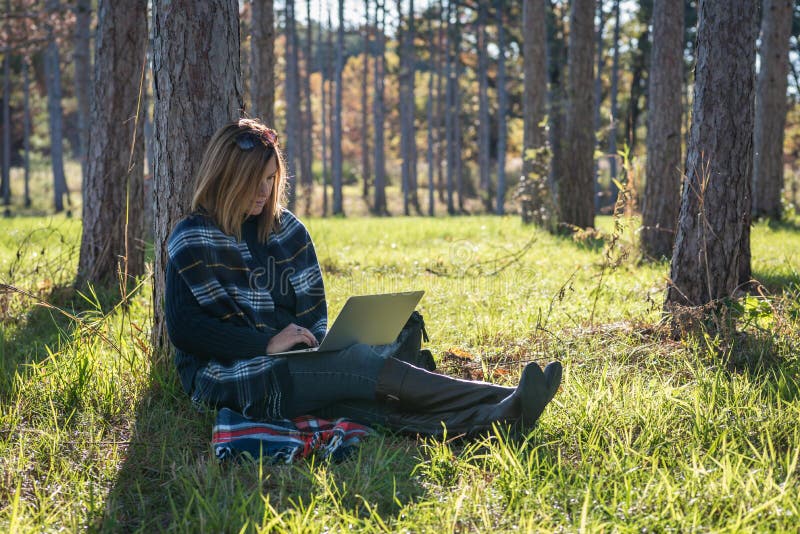 Woman Sitting Against Tree with Laptop Stock Photo - Image of natural ...