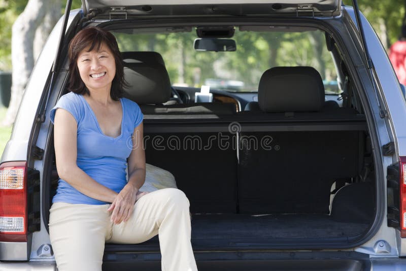 Woman Sitting in Back of Van Smiling Stock Photo - Image of outdoors ...