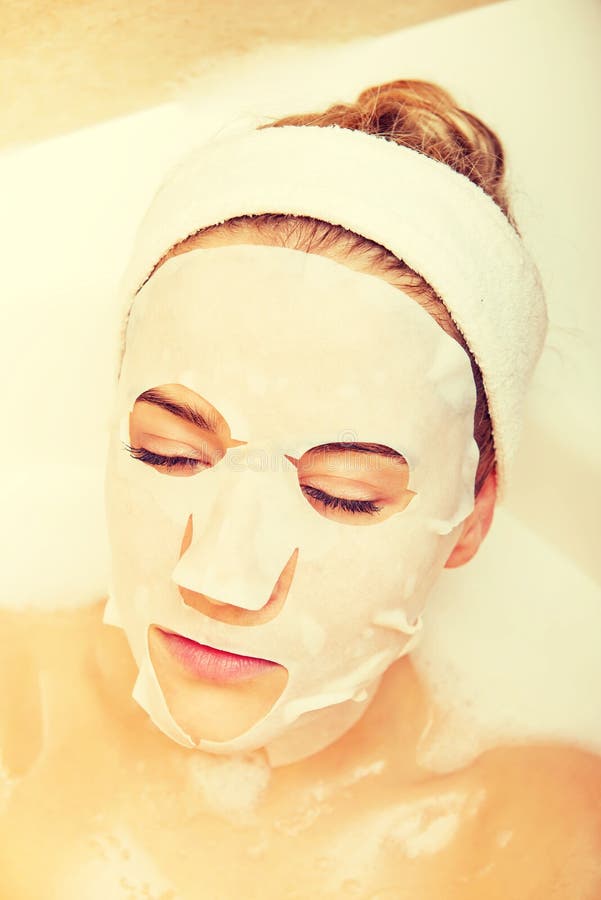 Woman Sitting in Bath with Face Mask Stock Photo - Image of body ...