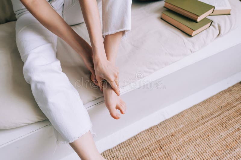 Woman Sitting On The Bed Massages Her Foot Close Up Woman With A