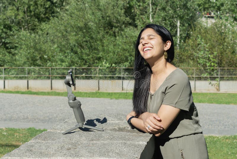 A Woman is Sitting on a Bench with a Camera in Front of Her Stock Image ...
