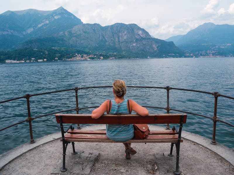 Woman Sitting on a Bench in Front Como Lake Stock Image - Image of ...