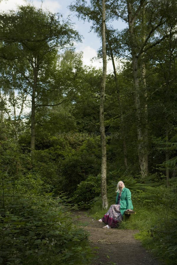 Woman Sitting on Bench beside a Path Stock Image - Image of green ...