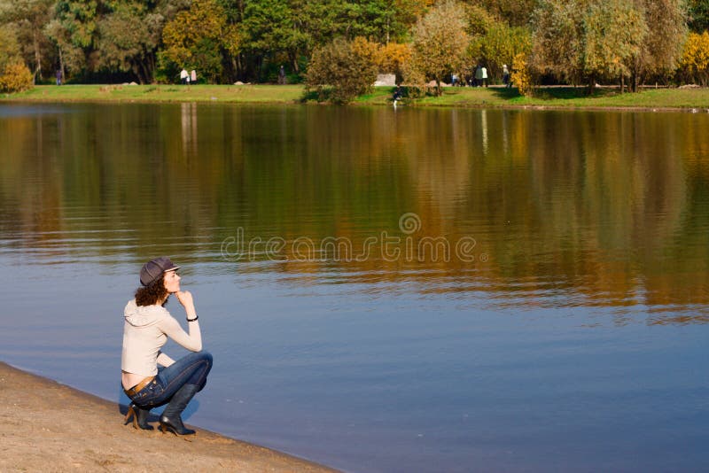 Woman Sitting on the Border of a River Stock Photo - Image of woman ...