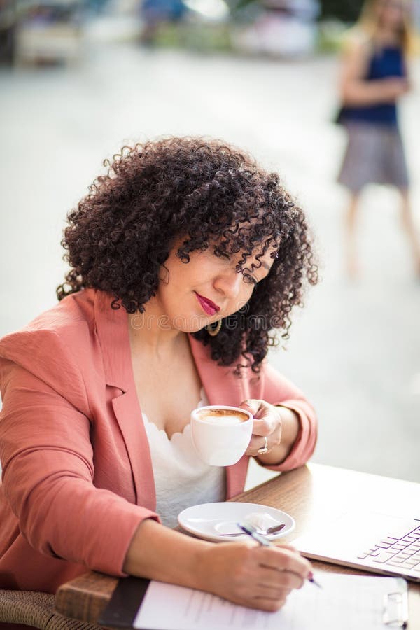 Woman Sitting in CafÃ© Writing on Document Stock Image - Image of ...