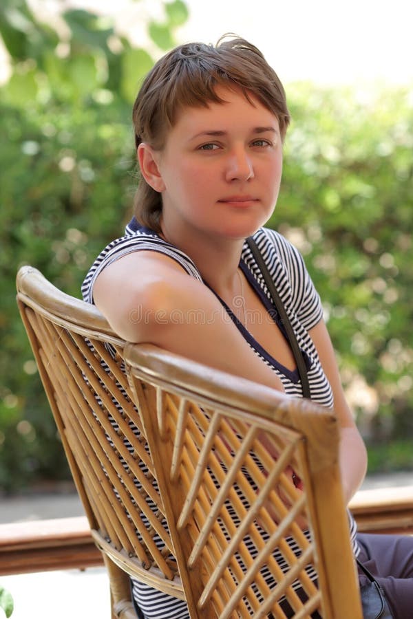 Woman is sitting on chair stock photo. Image of hair - 16594678
