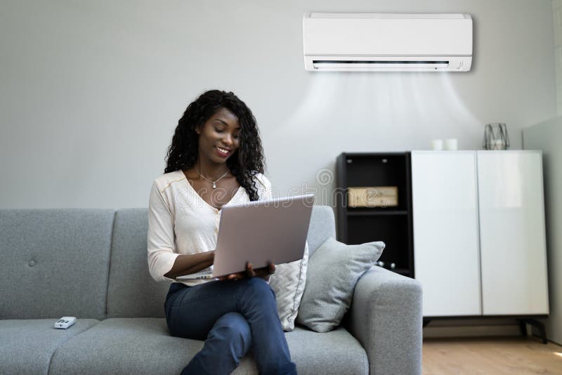 Woman Sitting on Couch with Air Conditioner Stock Image - Image of ...